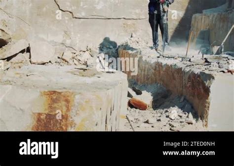 Working Male Builder At A Stone Quarry Crushes Stone With A Rock Drill Mining Of Sandstone
