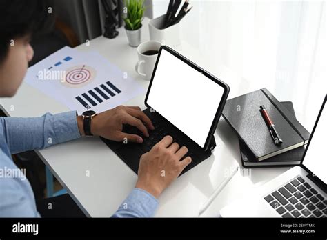 Businessman Using Tablet And Working On Data Document Graph Chart