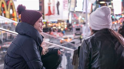 Two Girls In New York Enjoy The Amazing View Over Times Square By Night