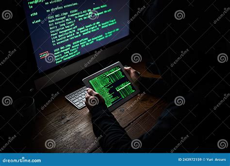 Coding Through The Night High Angle Shot Of An Unidentifiable Hacker