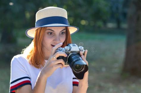 Pretty Teenage Girl With Red Hair Looking Amazed In Photo Camera In