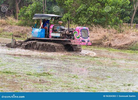 Agriculture Farmlandtractor With Plough Ploughing A Soil Field Stock