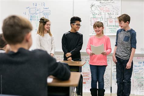 Classroom Students Present Group Project In Front Of Class By