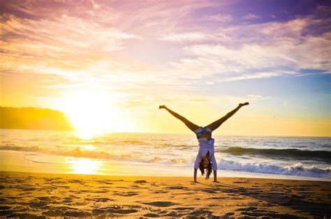Premium Photo Teenage Girl Practicing Headstand On Beach During Sunset