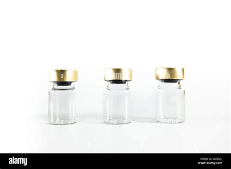 Three Small Empty Glass Vials On A White Background Medicine Bottles
