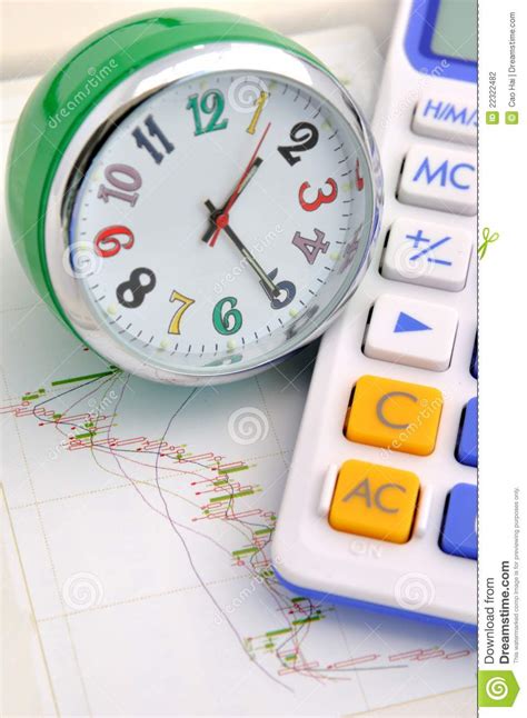 Clock And Calculator On Stock Graph Stock Photo Image Of Finance Calculator 22322482