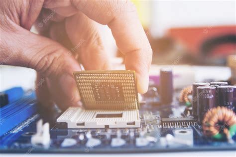 Premium Photo Technician Installing Cpu Chip To Socket On Motherboard