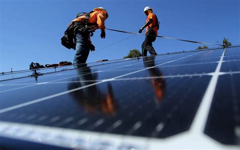 Download Technician Installing Solar Panels Wallpaper