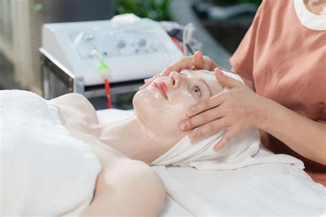 Premium Photo Beautiful Woman Having Facial Massage With Facial Mask