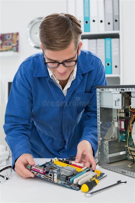 Young It Technician Repairing Computer In Modern Data Center Stock