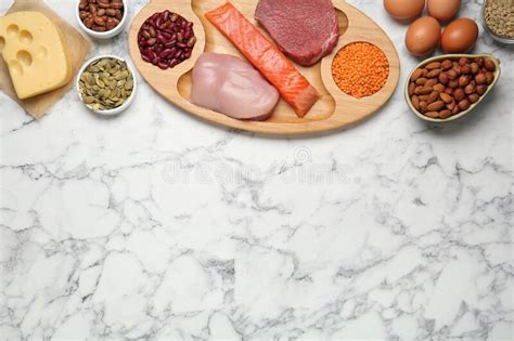 Different Fresh Products On White Marble Table Flat Lay And Space For
