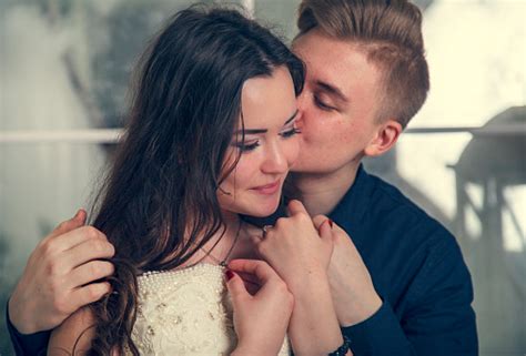 Young Loving Couple Kiss Each Other Cover Their Lips With A Candy In