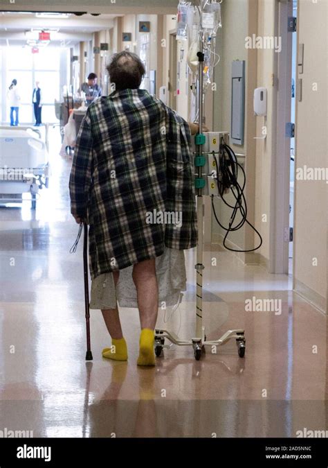 Patient Walking In A Hospital Corridor With A Mobile Iv Intravenous