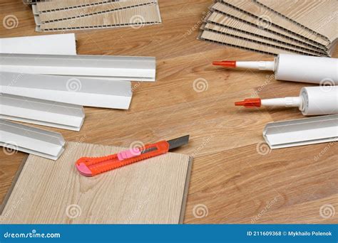 Set Of Items For Pvc Ceiling Indoor Works Assembly Adhesive Bottles And Pvc Panels With Plastic