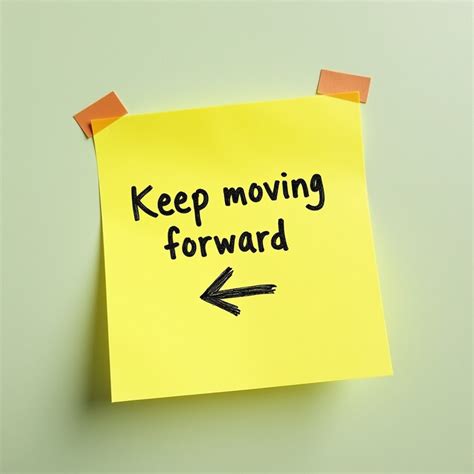 Photograph Of A Yellow Office Post It Note On A Random Office Surface