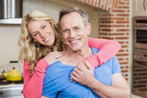 Premium Photo Happy Couple Hugging In The Kitchen