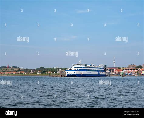 East Vlieland Village With Ferry Boat And Lighthouse From Waddensea