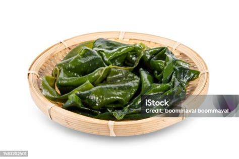 나무 그릇에 담긴 해초 또는 다시마는 흰색 배경에 격리되어 있습니다 나무 그릇에 담긴 라미나리아는 흰색 배경에 격리되어 있다