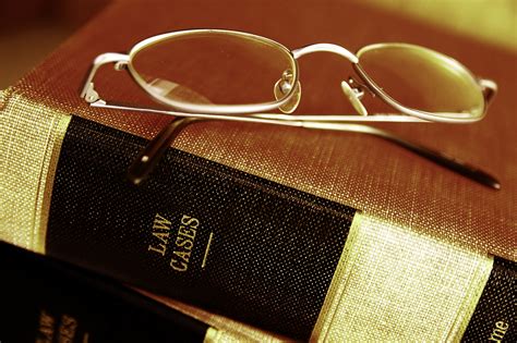 Sharp Focus Close Up Of Glasses Resting On Law Book Hd Wallpaper