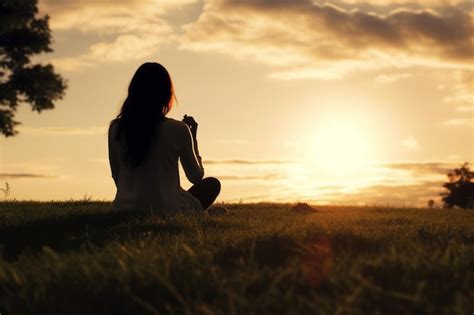 A Woman Sitting In The Grass Premium Ai Generated Image