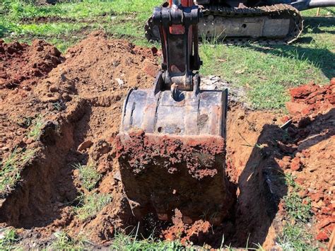 Premium Photo Backhoe To Renovate The Site In Preparation For Pouring