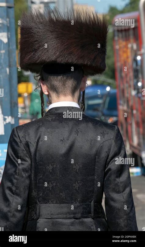 An Unidentified Orthodox Jewish Man With Long Peyus And Wearing A