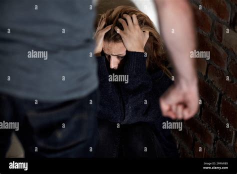Not Againabused Young Woman With Her Hands In Her Hair As Her Abuser