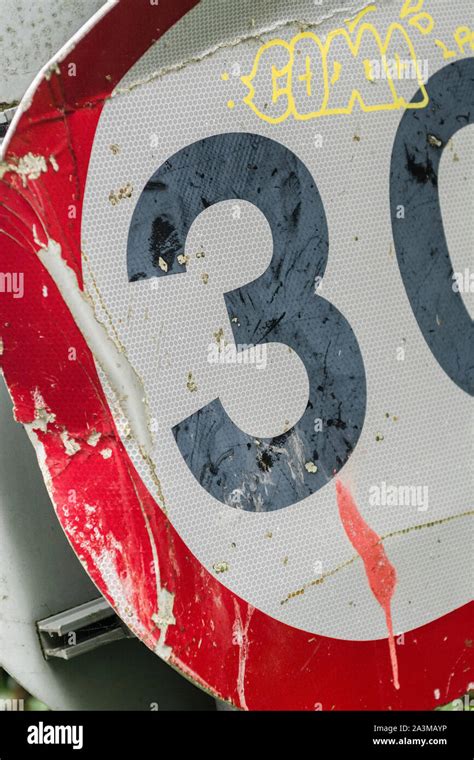 Battered Road Sign Indicating Speed Limit Of 40 MPH Or 40 Km Per Hour Even Number Rules Of