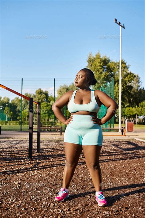 Empowering Curves Woman Embracing Fitness At Playground Stock Photo By Lightfieldstudios