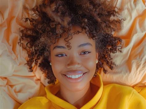 Premium Photo A Curly Haired Girl Lying In Bed Looking At The Camera