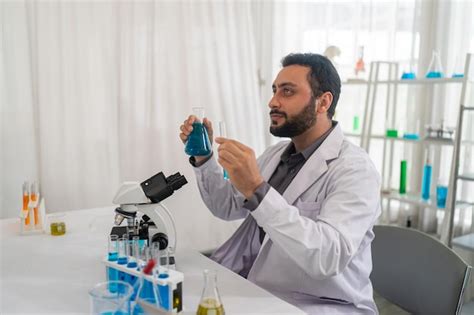 Premium Photo Lab Worker Using Magnifying Glass On Microscope