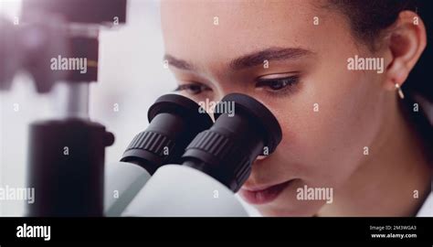What Do We Have Here A Young Scientist Using A Microscope In A Lab