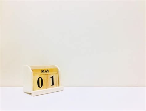 Premium Photo Calendar On Table Against White Background