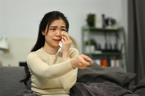 Sentimental Young Woman Crying And Wiping Tears With Paper Tissue While