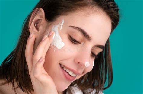Beautiful Girl Model With Natural Makeup Applying Moisturizer Cream On