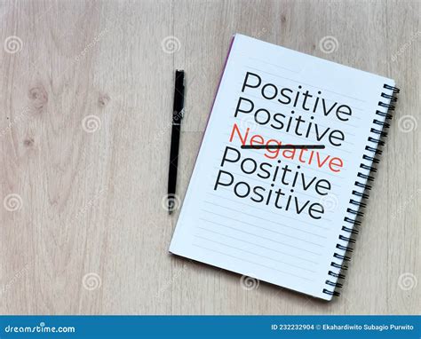 top view notebook with text positive and negative with a pen stock