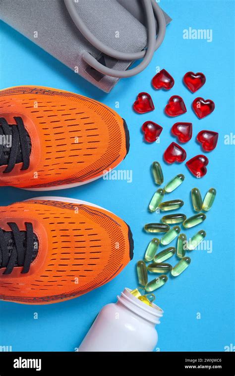 Yellow Capsules Of Unsaturated Fatty Acids And Red Glass Hearts