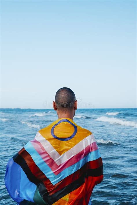 Man Wrapped In A Progress Pride Flag In The Ocean Stock Image Image