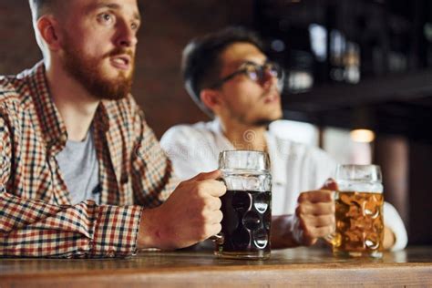 Talking With Each Other People In Casual Clothes Sitting In The Pub