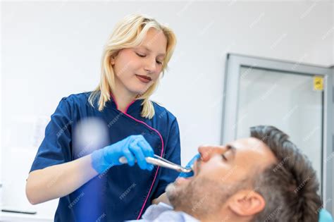 Premium Photo Treatment Of A Patient With A Dentist Surgeon