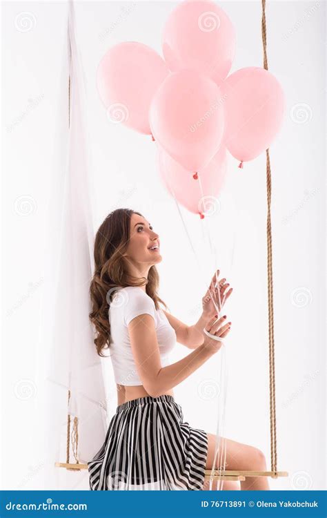 Joyful Girl Riding On Swing With Inflatables Stock Image Image Of