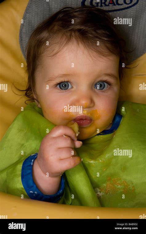 A Baby Girl Eating Food With Her Fingers Stock Photo Alamy