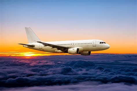 Premium Photo White Passenger Airplane Fly In The Sunrise Sky