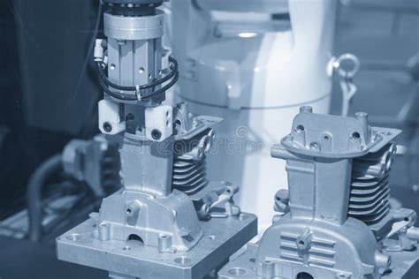 The Automatic Robotic Arm Gripping The Motorbike Engine Parts Stock