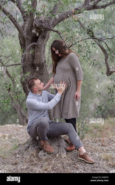 A Pregnant Young Woman In Olive Garden With Her Husband Sharing A