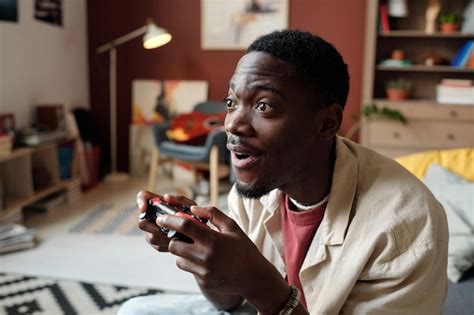 premium photo guy pressing buttons on controllers