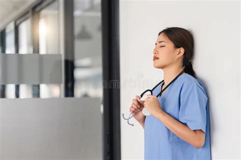 Tired Exhausted Nurse Or Doctor Taking A Break In The Clinic Corridor