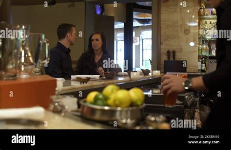 Waiter Serving Alcohol To A Young Couple In A Bar Stock Video Footage