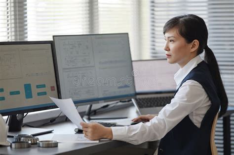 asian woman as female engineer using computer with blueprints on screen stock image image of