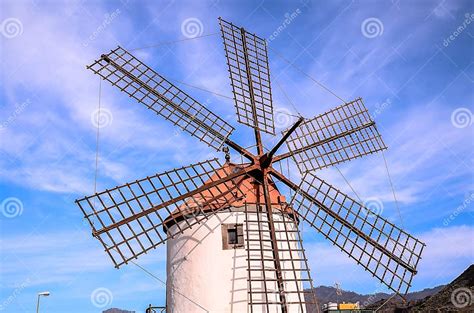A Windmill With A Red Roof Is Standing In A Field Stock Image Image